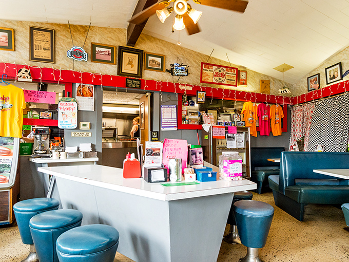 The counter area serves as both kitchen command center and social hub, where regulars exchange local news between bites of perfect burgers.