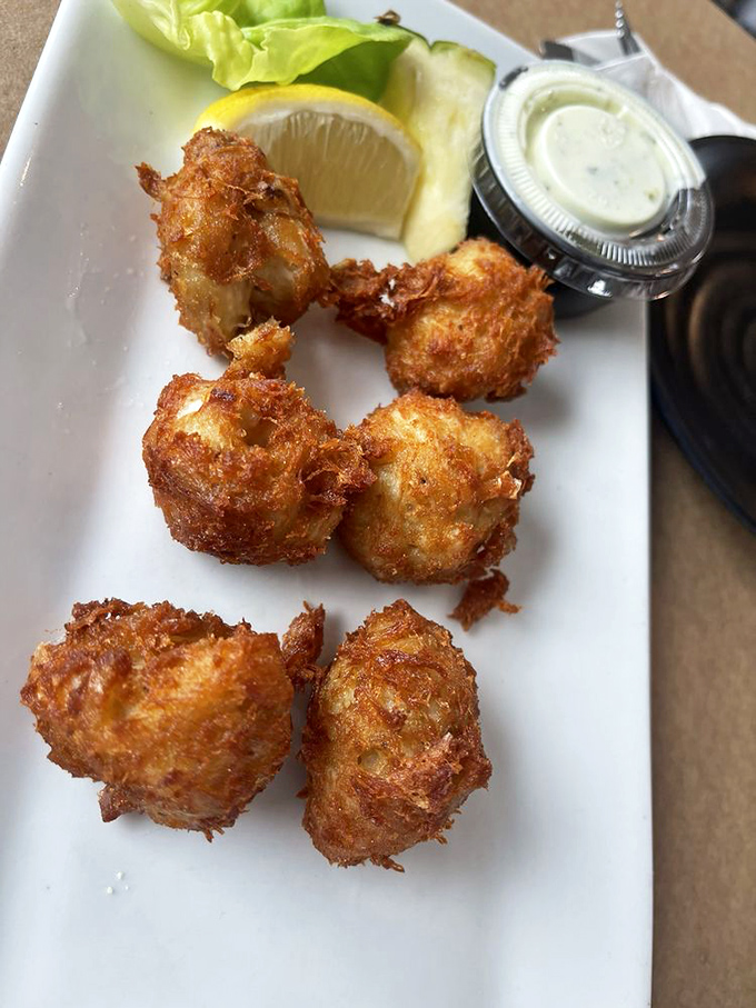 Crab fritters so golden and crispy they deserve their own trophy case. Like little seafood hand grenades that explode with flavor.