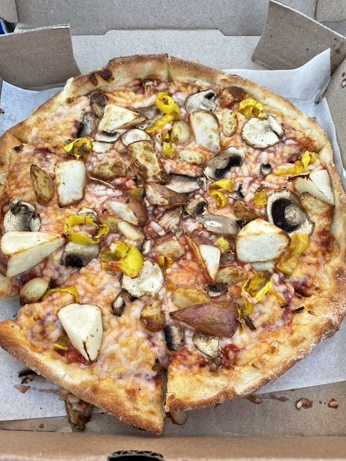 Mushrooms and banana peppers create a fungi-meets-spice symphony. This pizza proves that vegetarian options don't have to be boring consolation prizes.
