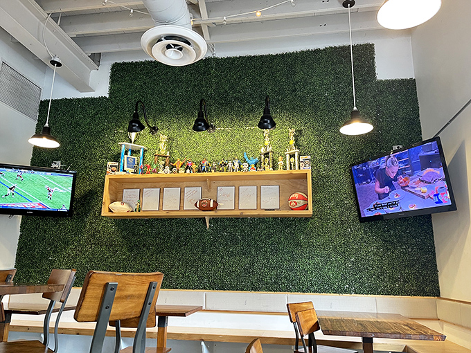 That green wall isn't just d&eacute;cor&mdash;it's a statement piece that says, "Yes, we take our chicken seriously, but we're not above having fun with our space."