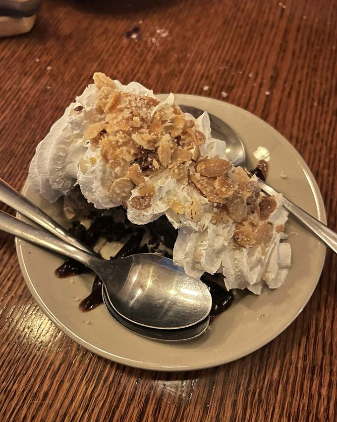 This dessert looks like it's wearing a party hat of whipped cream and crunchy toppings. Sweet endings that make you forget you came for the steak.
