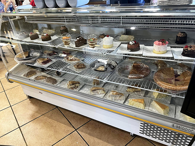The dessert case—where good intentions go to die and "I'll just have coffee" turns into "and a slice of that chocolate cake."