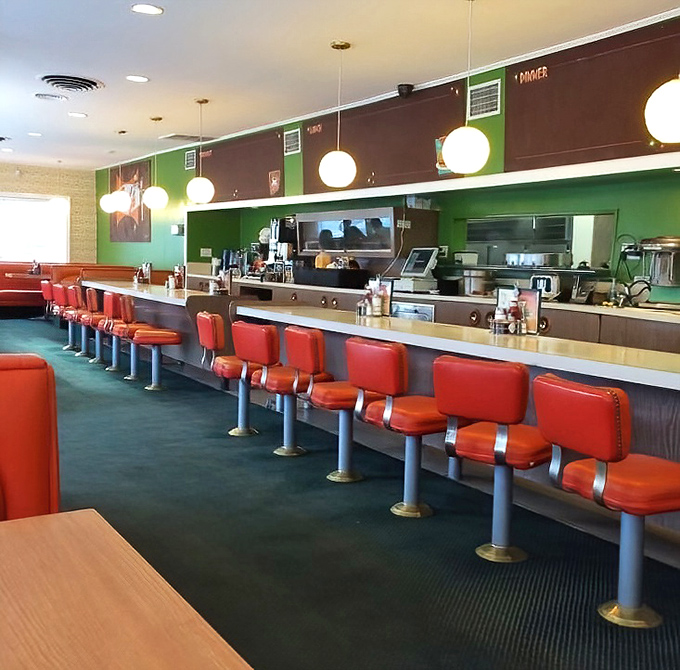 The counter seats offer front-row tickets to the breakfast theater happening behind that gleaming service window.