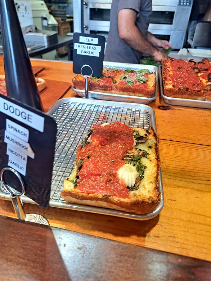 The "Dodge" announces itself with a car key tag but delivers with spinach, mushroom, and ricotta. Detroit automotive pride meets Italian culinary tradition.