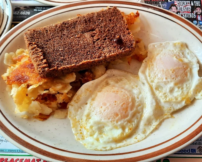 Two sunny-side up eggs keeping watch over a kingdom of home fries and that mysterious Delaware delicacy known as scrapple.