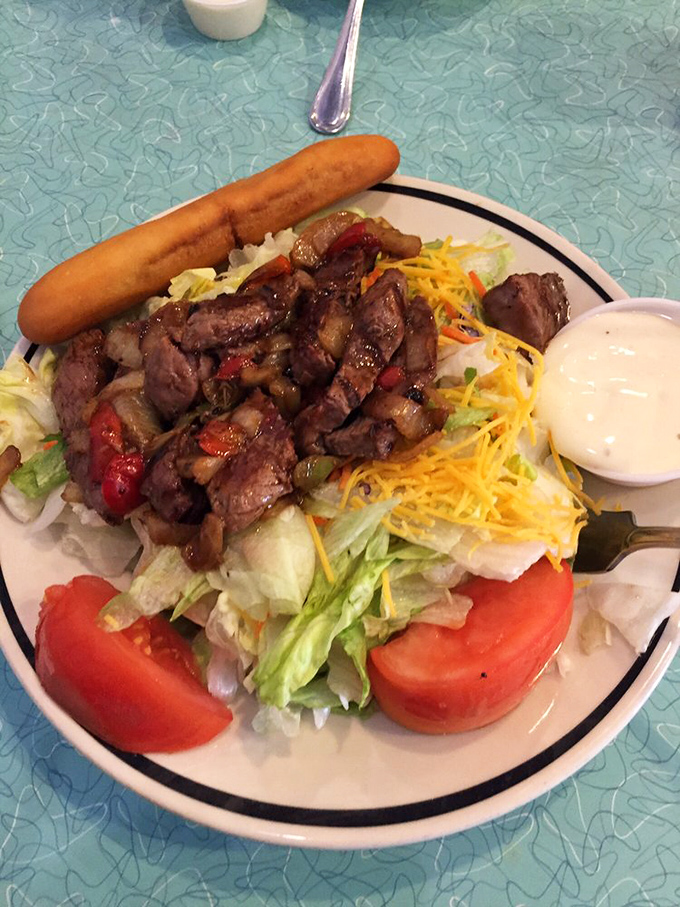 A steak fajita salad that lets you pretend you're eating healthy while enjoying every savory, protein-packed bite. The breadstick is non-negotiable.