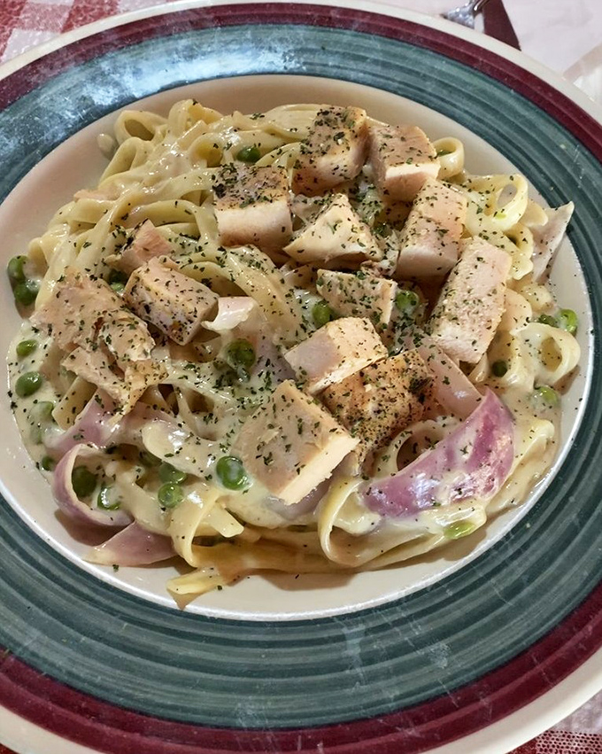 Fettuccine Alfredo with chicken and peas—comfort food that hugs you from the inside out. The kind of dish that makes you want to nap afterward.