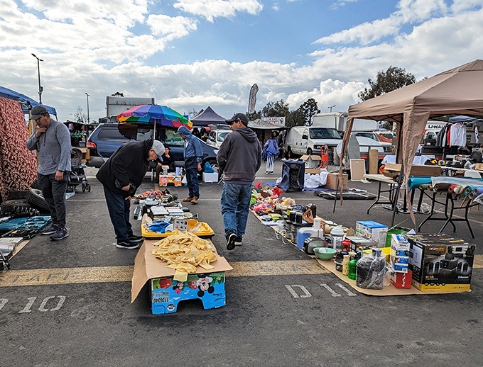 The ground becomes retail space when bargain hunters gather. One person's random household items become another's "exactly what I was looking for!" 