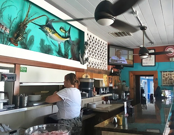 The open kitchen showcases a stunning marine mural that reminds you exactly where your fresh catch of the day is coming from.
