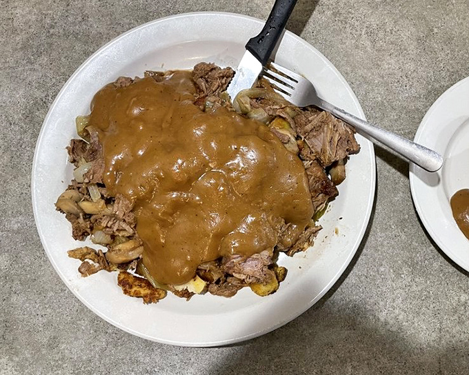 Pot roast swimming in gravy so good you'll consider drinking it with a straw. Comfort food that understands the assignment.