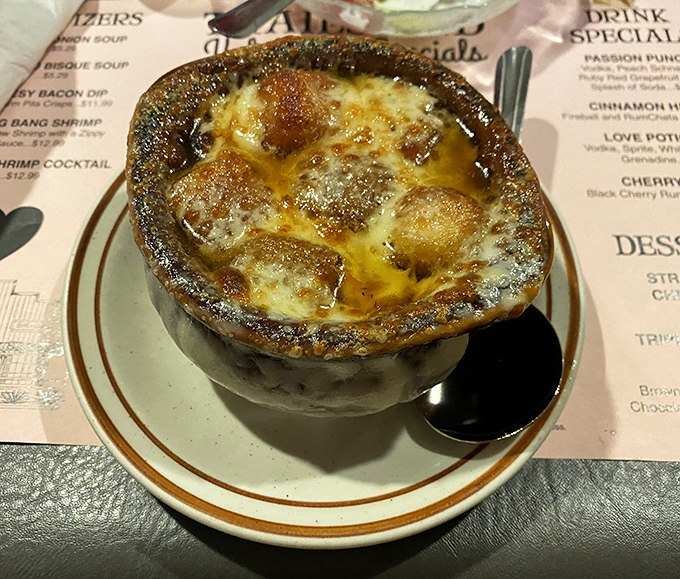 French onion soup bubbling away under its cheese blanket, like a delicious volcano of comfort.