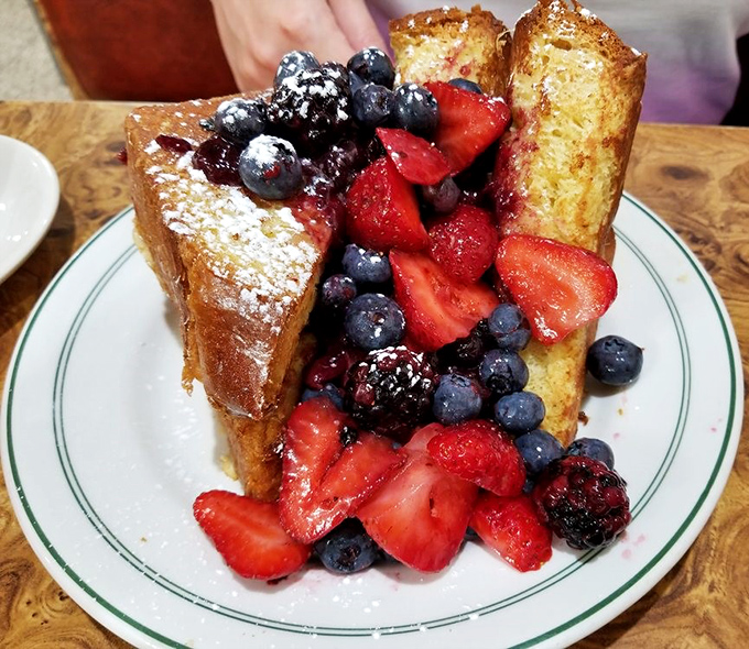 French toast that's having more fun than you are, dressed up with berries in what can only be described as breakfast's finest formal wear.