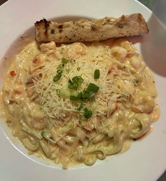 Pasta swimming in a sea of creamy decadence. This garlic cream linguini with seafood is like a warm hug for your taste buds.