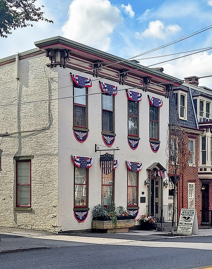 Patriotic bunting adorns historic buildings where American history comes alive through carefully preserved artifacts and stories.