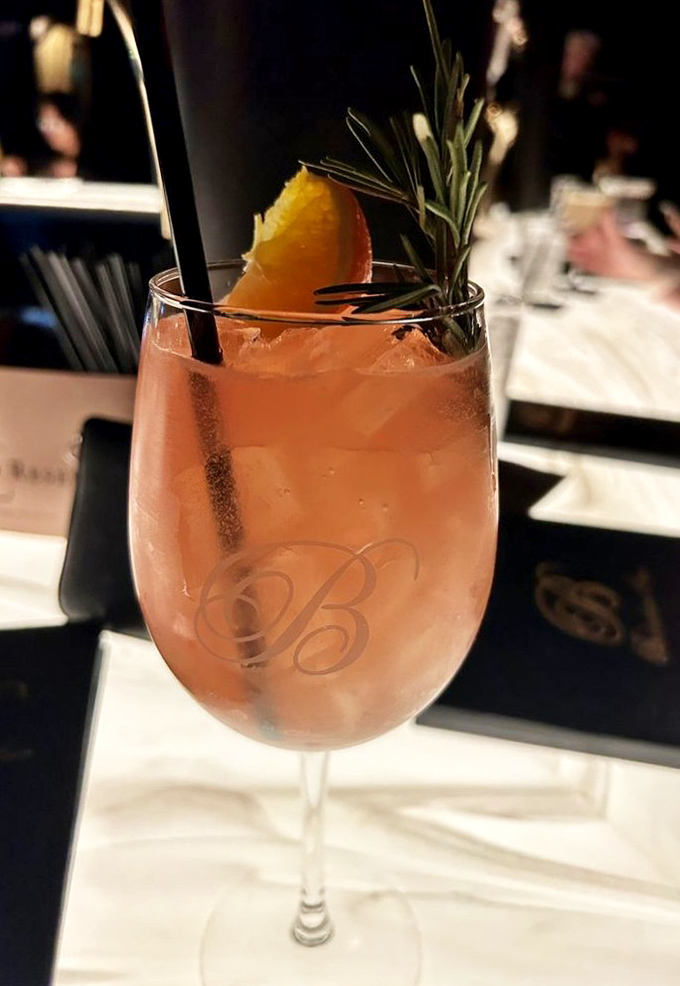 A cocktail that looks like a Pennsylvania sunset in a glass. That rosemary sprig isn't just garnish&mdash;it's aromatherapy.