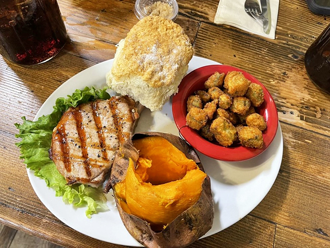 This isn't just lunch &ndash; it's a complete Ozark experience. Grilled pork chop, sweet potato, and those golden-fried okra nuggets that disappear too quickly.