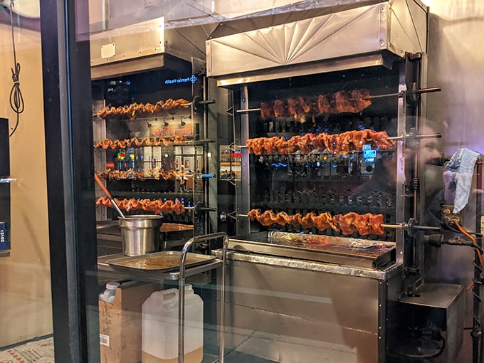 Barbecue is theater, and this rotating display of chickens is Broadway-worthy. The glass window is there because some performances deserve an audience..