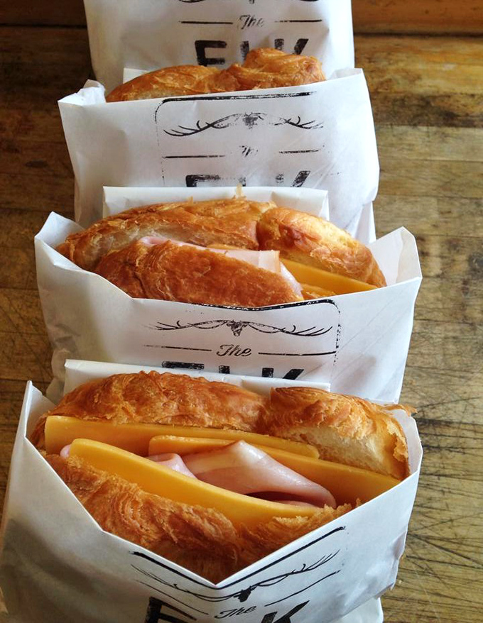Croissant sandwiches lined up like buttery soldiers, ready to battle hunger with layers of ham and cheese. Resistance is futile.