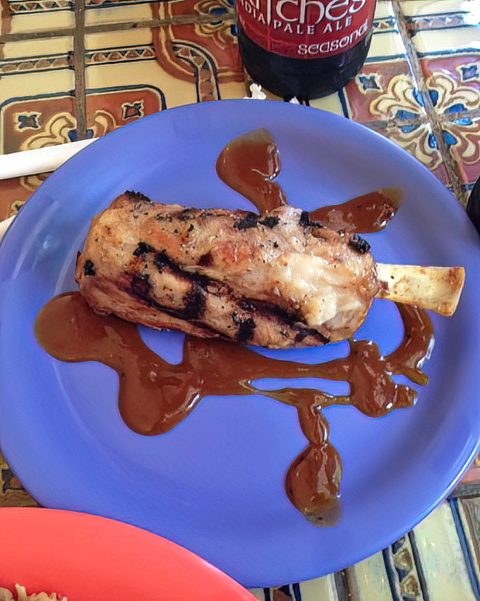 This isn't just a piece of meat—it's a statement. The sauce artfully drizzled across the plate says, "Yes, we take barbecue seriously."