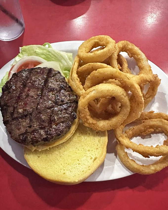 The burger and onion rings combo that's launched a thousand diet cheat days—that jalapeño on top is nature's way of saying "you're welcome."