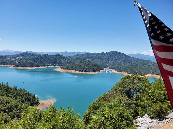 That moment when you realize Mother Nature is showing off. Shasta Lake's azure waters frame a landscape worthy of a national park poster.