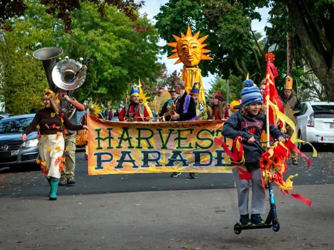 The Harvest Parade brings community creativity to life with homemade sun puppets and musical instruments, no corporate floats or candy-throwing politicians required.