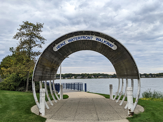 The Heinz Waterfront Walkway—an architectural portal that frames Lake Macatawa like nature's own masterpiece deserving a proper introduction.