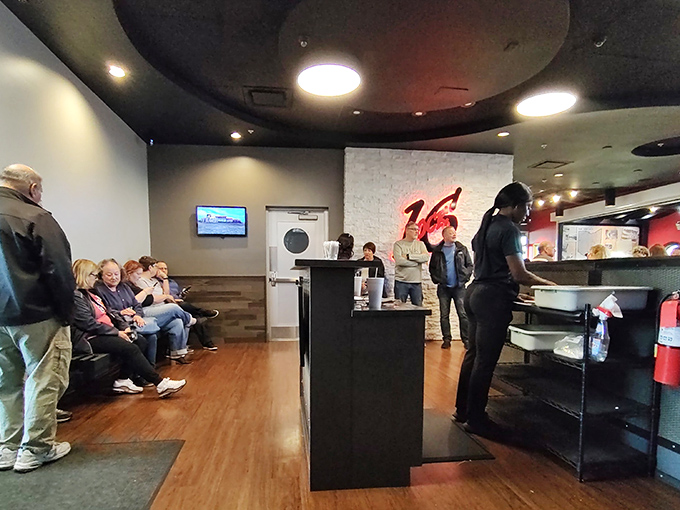 The waiting area where anticipation builds and the aroma of grilled steaks makes those few minutes feel like delicious torture.