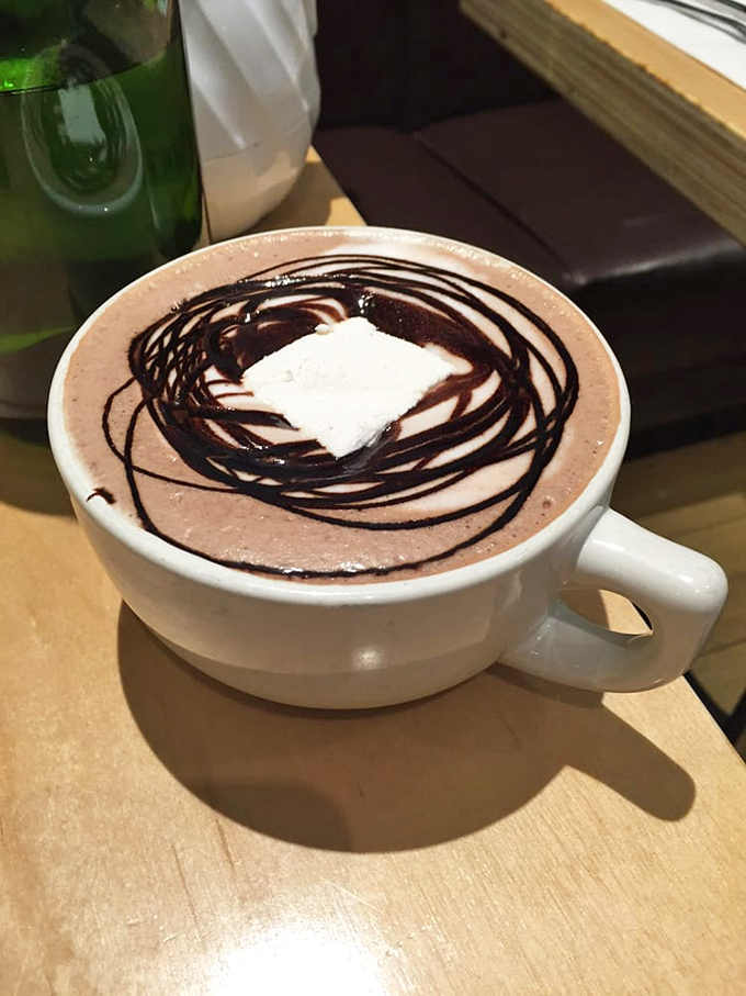 Hot chocolate that doesn't just warm your hands&mdash;it hugs your soul. Those chocolate drizzles aren't decoration; they're a promise.