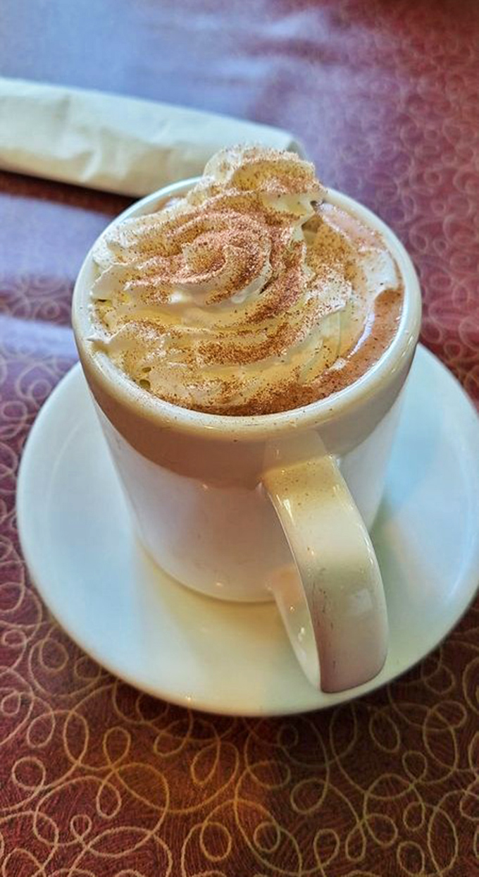 Hot chocolate topped with whipped cream and cinnamon—winter comfort in a mug, even when Oakland's thermometer disagrees.