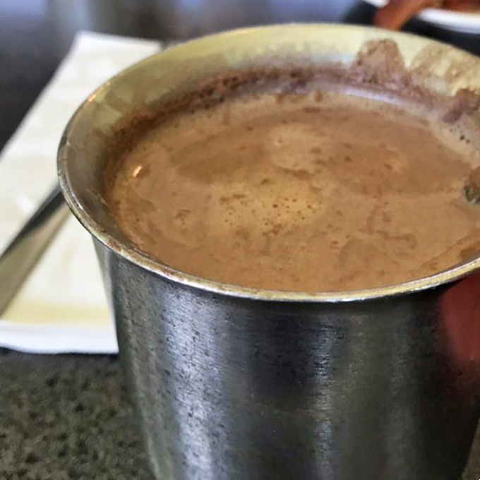 Hot chocolate served in a metal cup—keeping it warm while simultaneously giving you that nostalgic feeling of drinking cocoa at your grandmother's house.