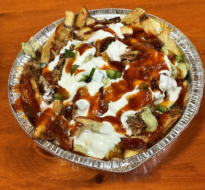 They call it a "hot mess" for good reason&mdash;fries smothered in pulled pork, sauce, and what appears to be all things wonderful in this world.