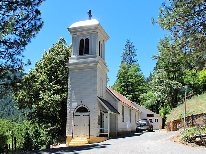 This pristine white church seems to glow against the forest backdrop, a spiritual sanctuary that's witnessed generations of mountain life.