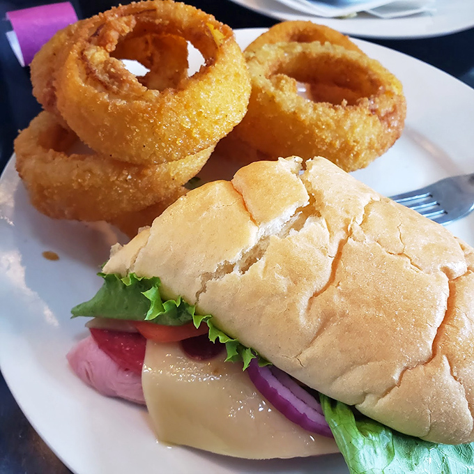 The onion rings deserve their own zip code, while the sandwich brings together the perfect ratio of bread, meat, cheese, and vegetables—a harmony rarely achieved in sandwich architecture.