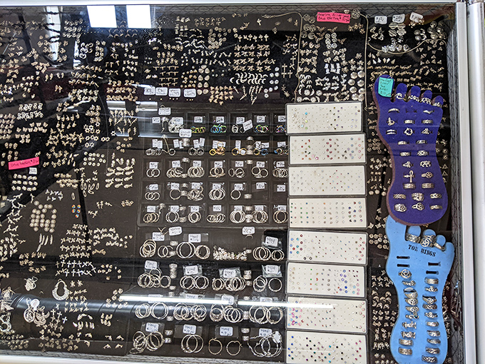 A dazzling display of jewelry transforms this glass case into a treasure chest, with hundreds of rings and pendants catching the light and shoppers' eyes.