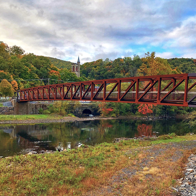 Fall foliage frames the pedestrian bridge, creating a scene so perfectly autumnal it could be the cover of "New England Living" (despite being in Pennsylvania).