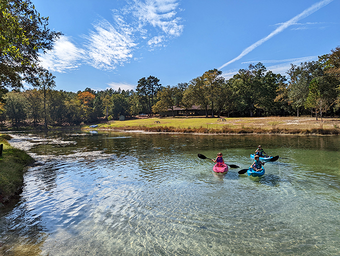 Paddling through nature's watercolor painting. These kayakers navigate crystal-clear waters that would make your Instagram filters utterly redundant.