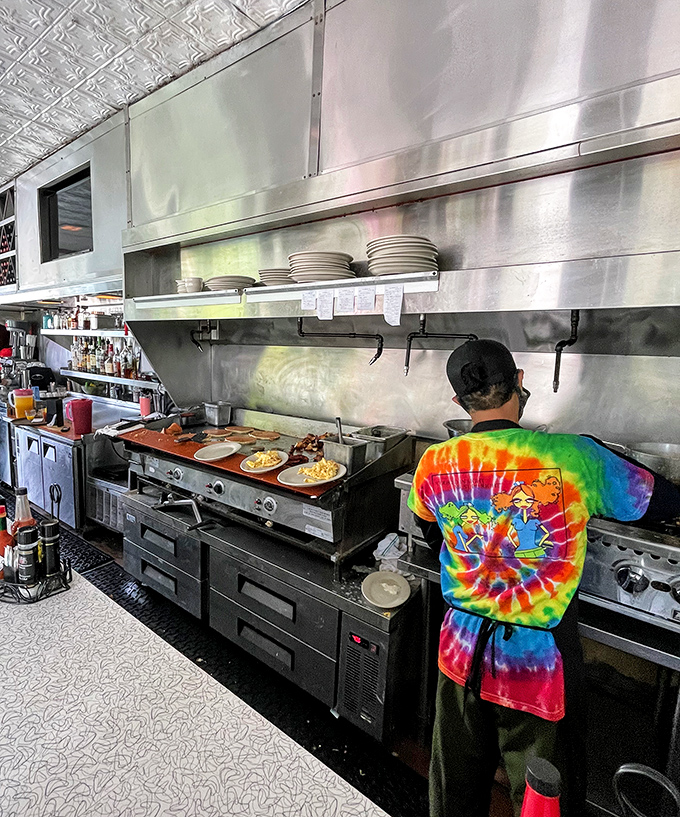 Behind the scenes magic&mdash;a tie-dye clad chef orchestrates breakfast symphonies on a well-seasoned grill that's seen more eggs than a chicken farm.