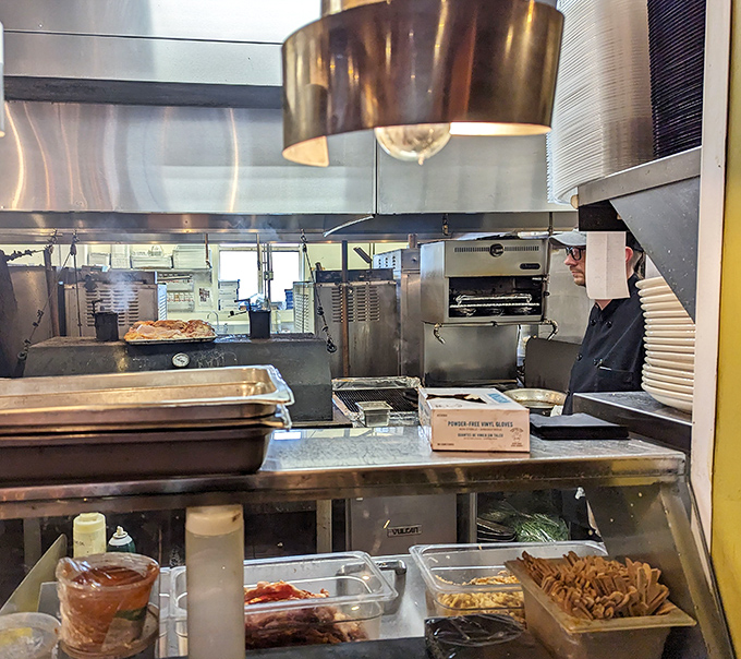 Behind the scenes where smoke and magic happen. The kitchen reveals glimpses of the careful craft behind each plate of barbecue perfection.