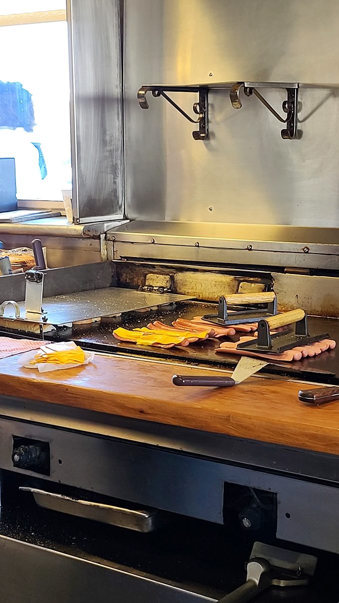 The well-seasoned grill tells stories of thousands of perfect burgers. Those hot dogs are about to join a very delicious legacy. 