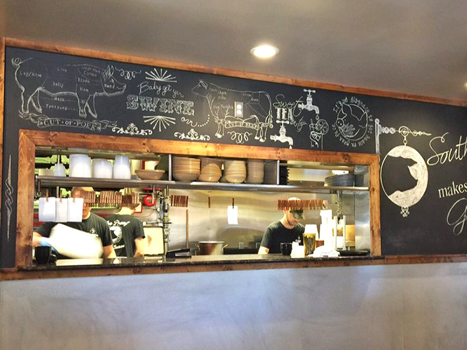 A glimpse into BBQ headquarters through the kitchen window. That chalkboard diagram of meat cuts is basically a work of art.