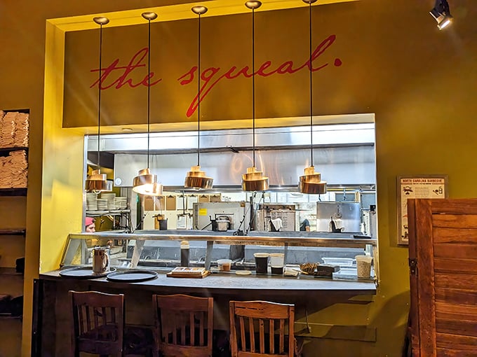 "The Squeal" kitchen window offers a glimpse into barbecue alchemy, where pitmasters transform humble ingredients into transcendent experiences.