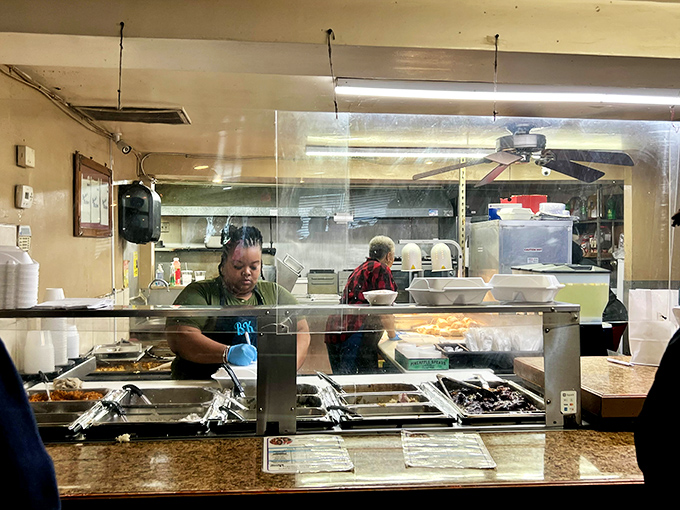 Behind the glass partition, culinary magic happens—where recipes passed down through generations transform simple ingredients into legendary meals.
