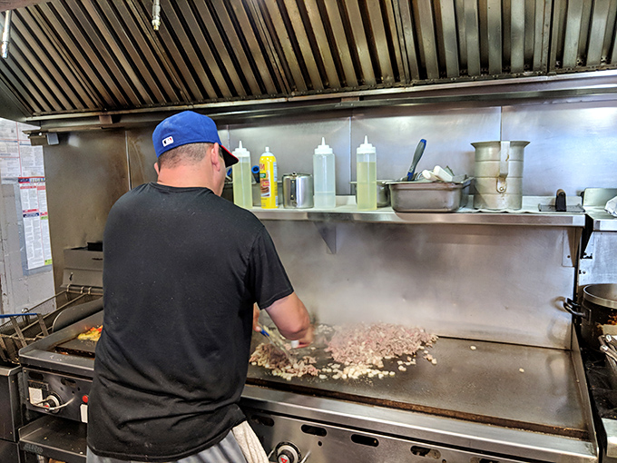 Where the magic happens. That flat-top grill has seen more action than most Broadway stages, and the results are equally dramatic.