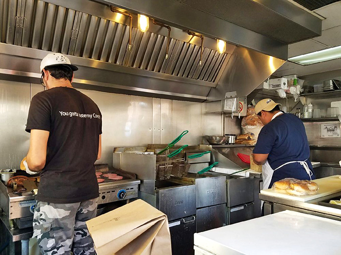 The kitchen window frames culinary theater where the real magic happens – no smoke and mirrors, just great cooking.