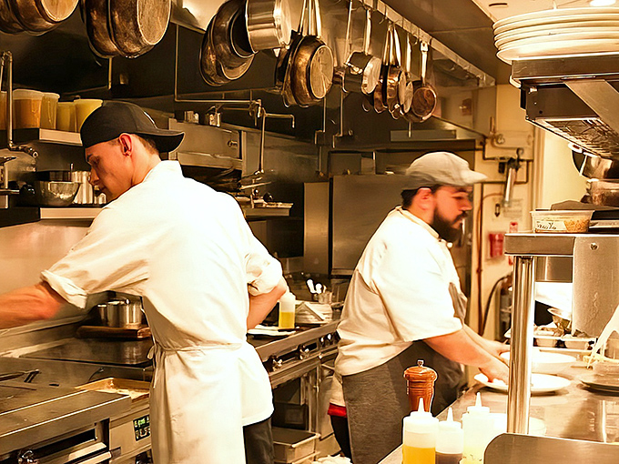 The kitchen ballet&mdash;where the magic happens. Pots hanging overhead like delicious possibilities waiting to drop onto your plate.