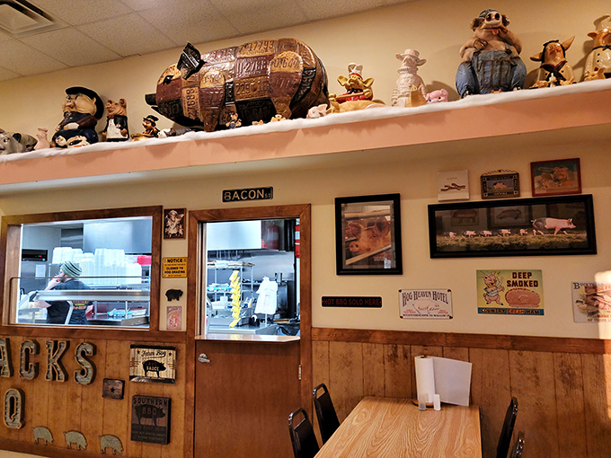 The collection of pig figurines watching over the kitchen is both whimsical and a solemn reminder of the noble sacrifice behind great barbecue.