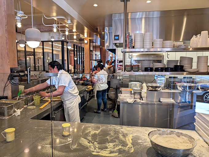 Where the magic happens! Flour-dusted counters and focused chefs turning simple ingredients into edible art. Better than theater.