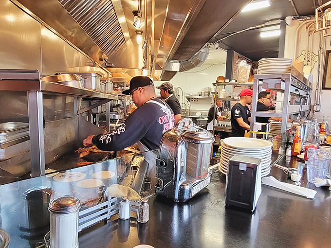 The kitchen crew moves with choreographed precision, turning out plate after plate of breakfast magic. This is where the morning miracles happen.