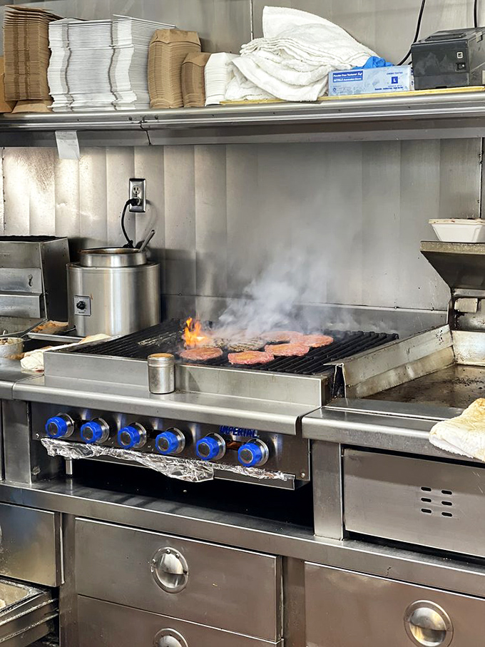 Where the magic happens &ndash; flames kiss patties into submission while skilled hands orchestrate the burger symphony.